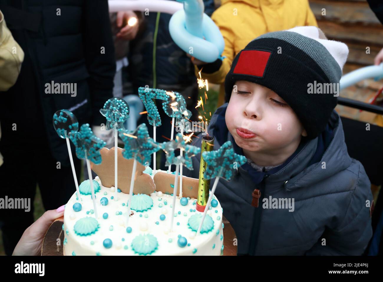 Portrait of kid blows out candle on birthday cake Stock Photo - Alamy