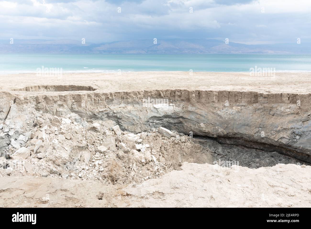 Sinkhole filled with turquoise water, near Dead Sea coastline. Hole ...