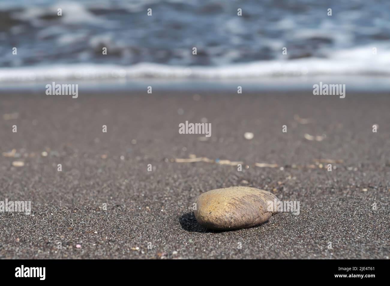 A stone at the famous beach of Perissa in Santorini Greece Stock Photo ...