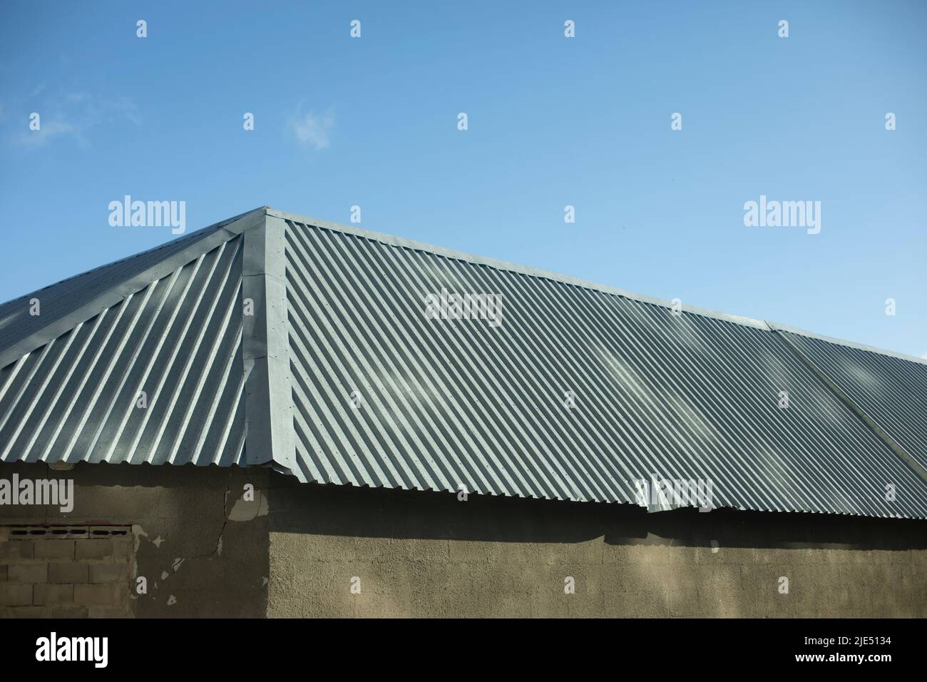Stainless steel roof. Steel roof of house. Small building. Details of ...