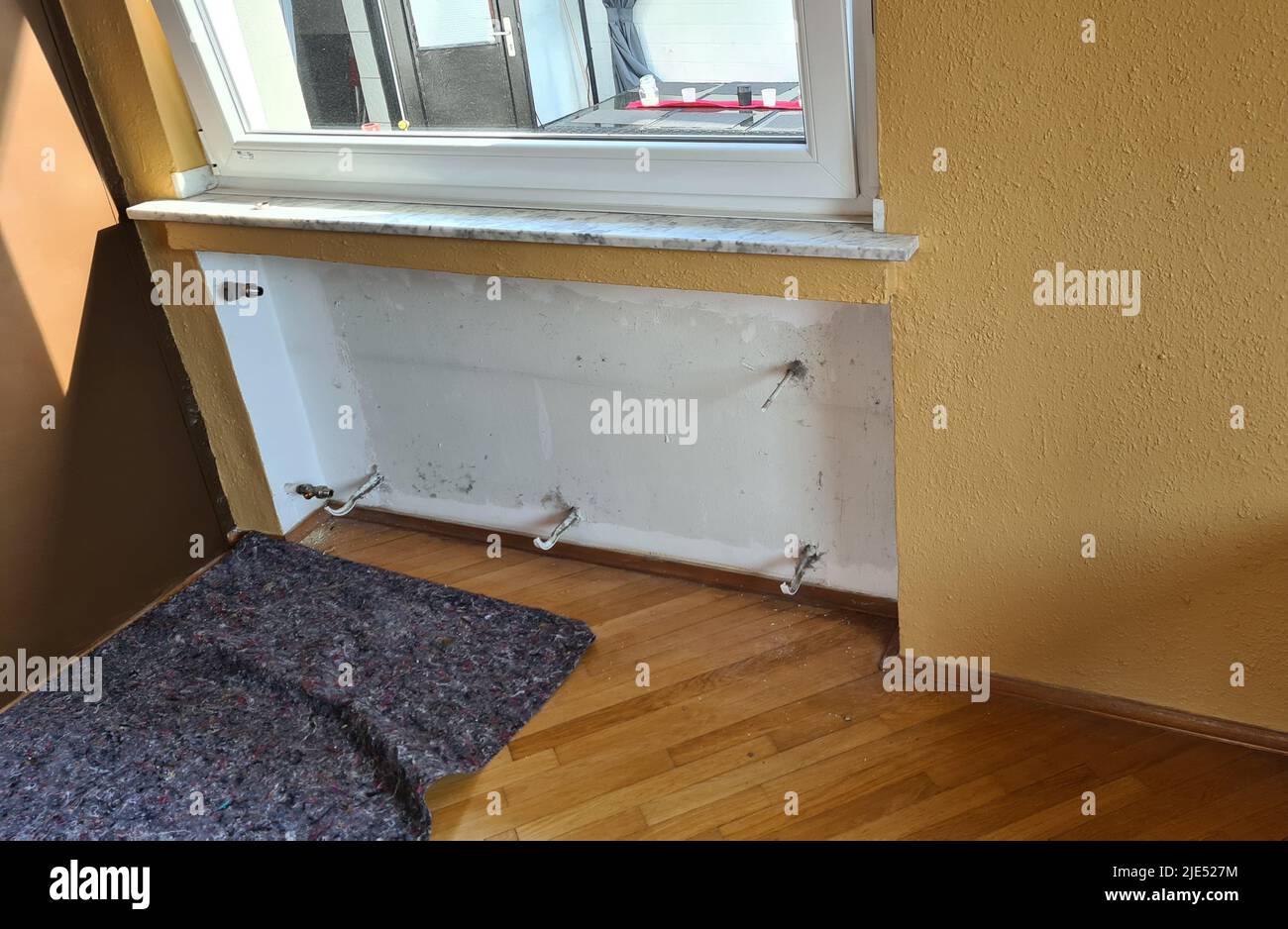 Dismantling a broken radiator in a private house. Radiator Stock Photo ...