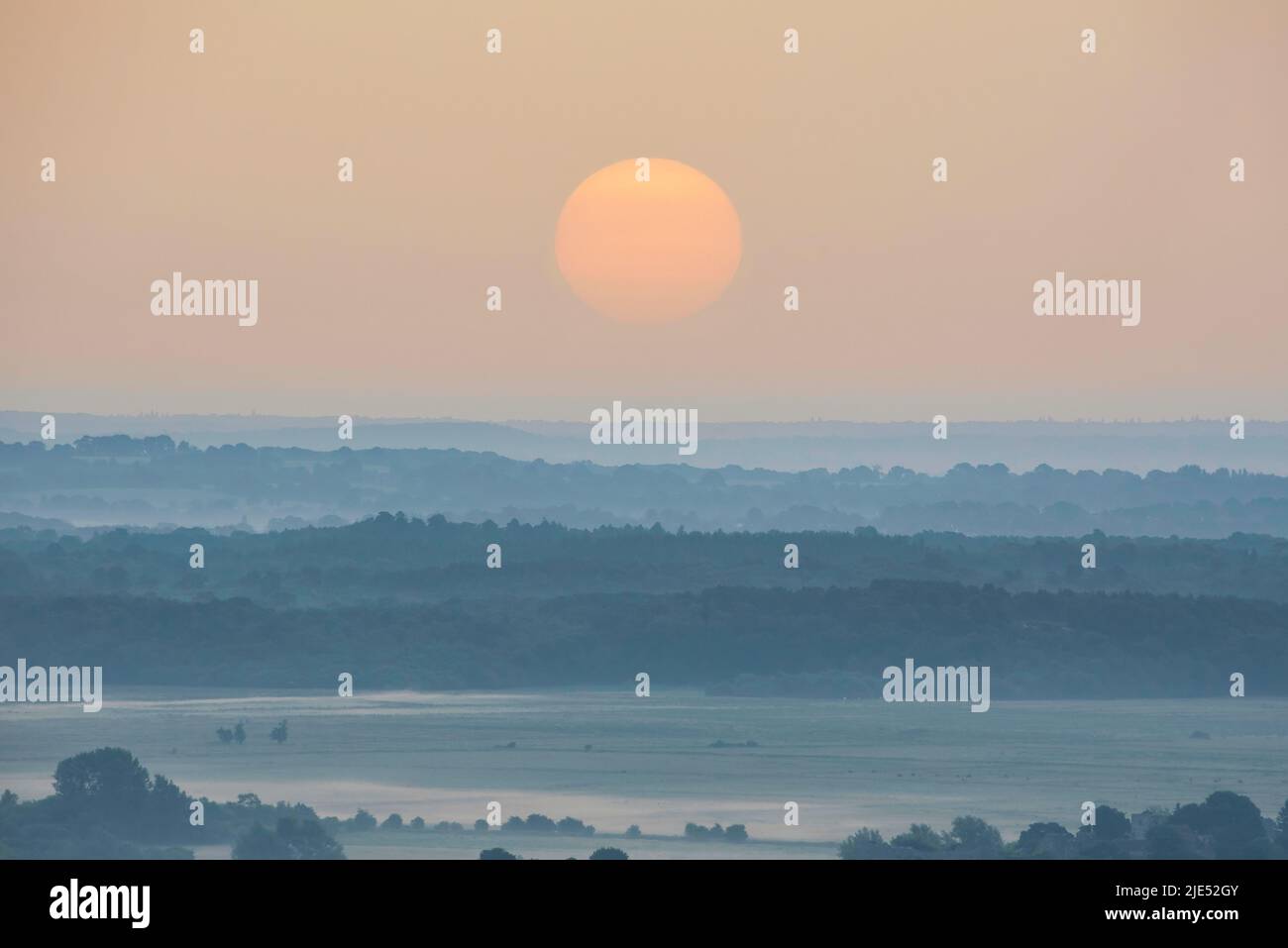 Beautiful Summer sunrise landscape image looking over fields with mist ...