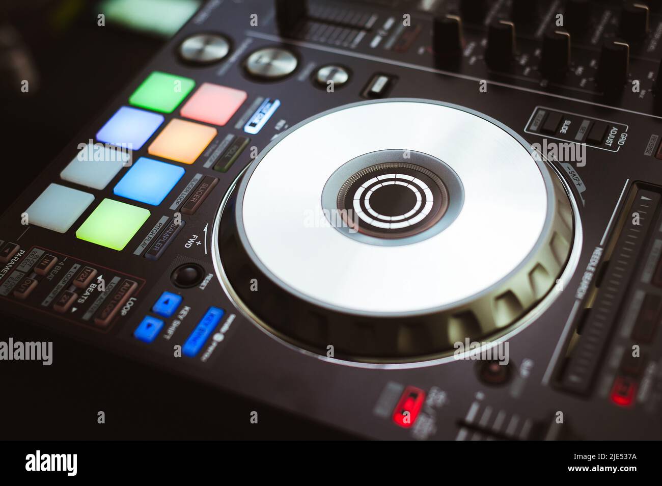 DJ plays and mix music on digital midi controller Stock Photo - Alamy
