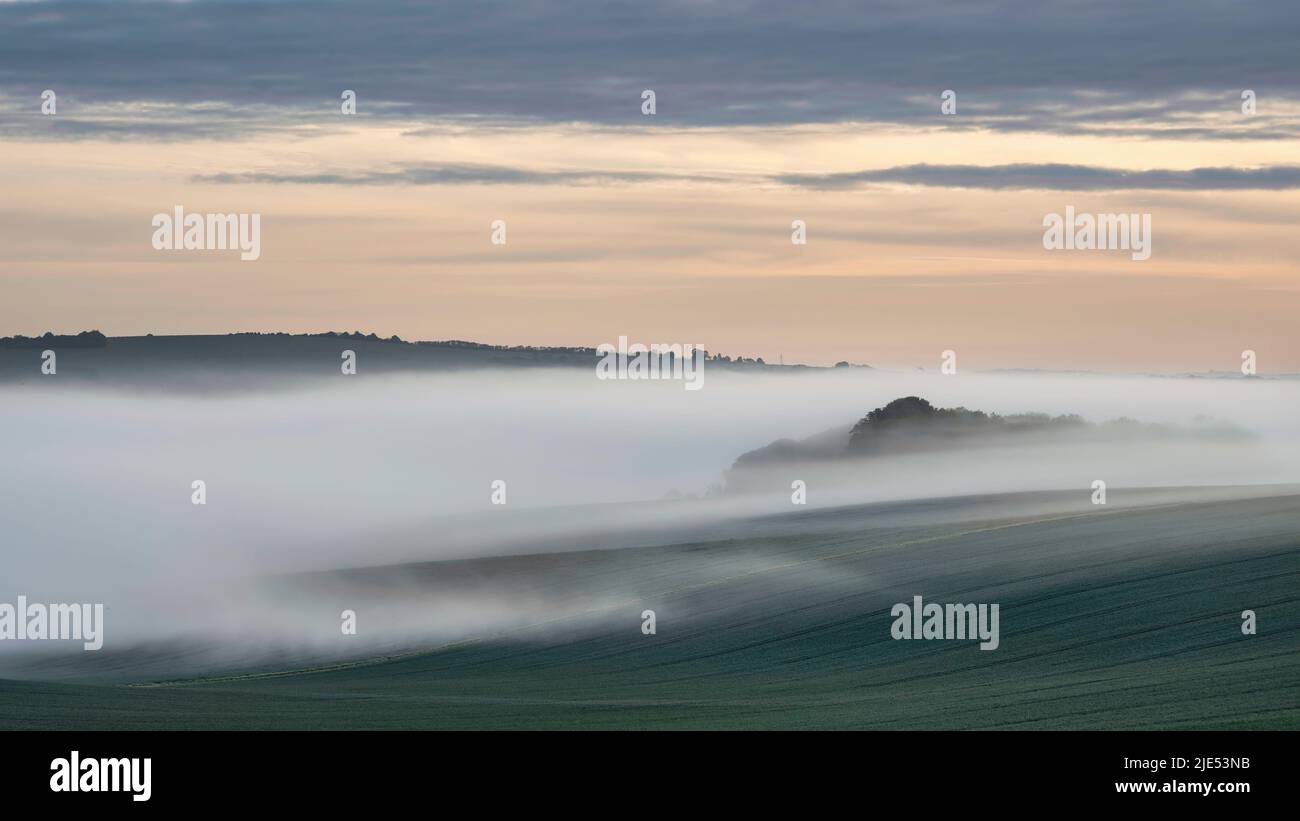 Beautiful landscape image of sea of fog rolling across South Downs ...