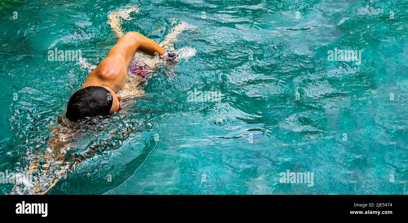 Man swimming freestyle in the pool. Triathlon fitness athlete swimming ...