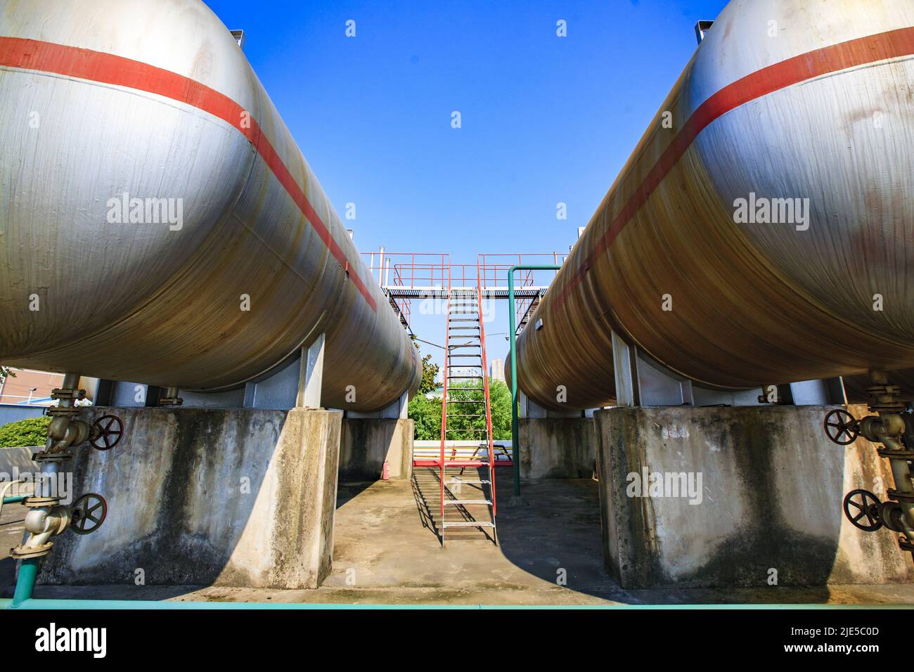 Industrial outdoor sunshine blue sky natural gas Stock Photo - Alamy