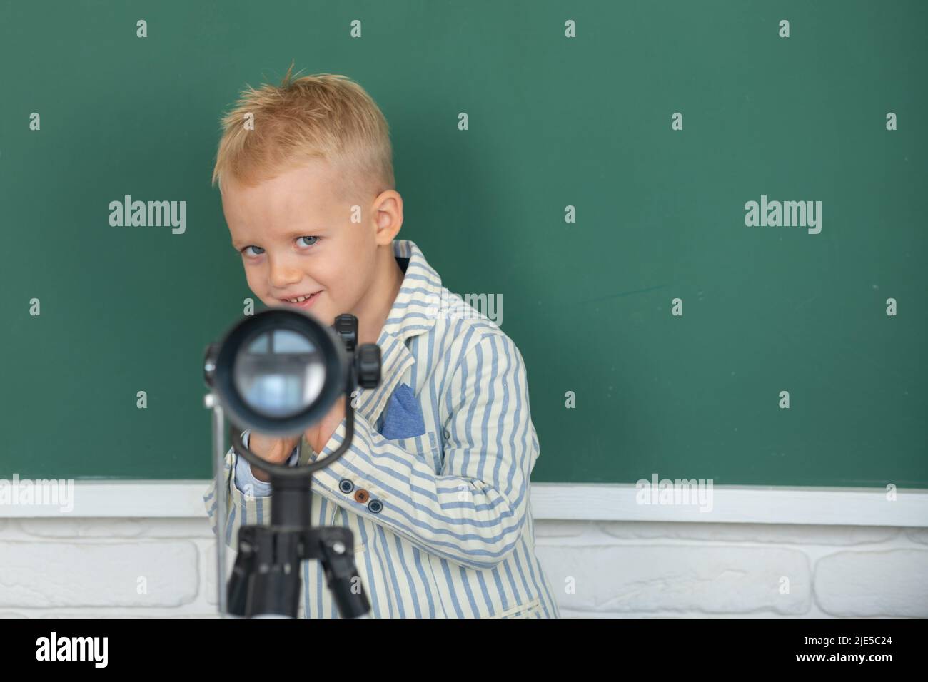Portrait of pupil with telescope in class at elementary school Stock ...