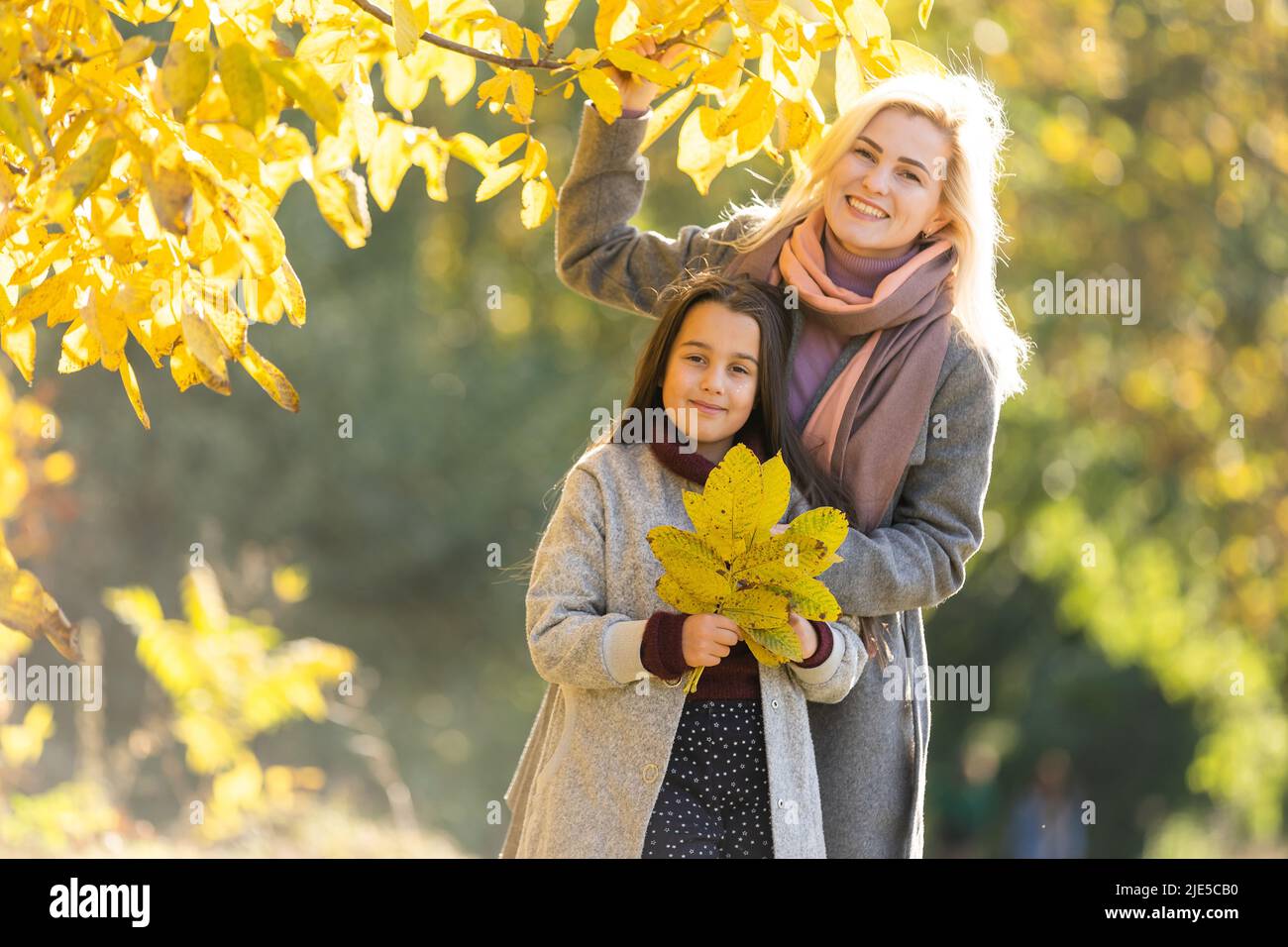 Mom with her daughter during autumn Stock Photo - Alamy