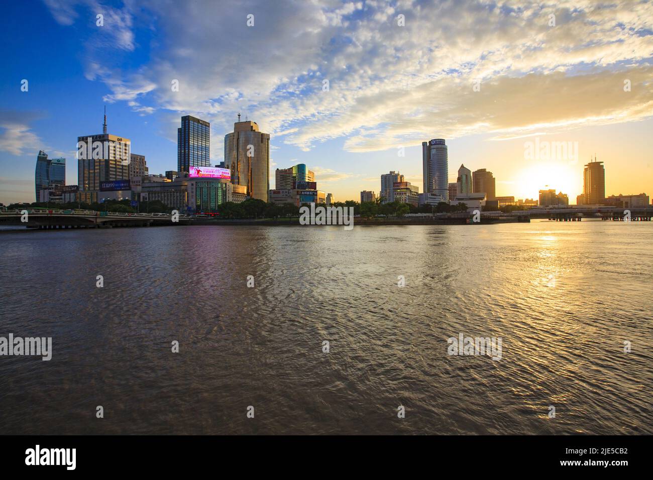Urban high-rise buildings and sunshine reflection scenery of rivers in ...