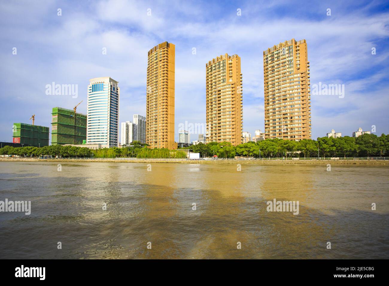 Urban high-rise buildings and sunshine reflection scenery of rivers in ...