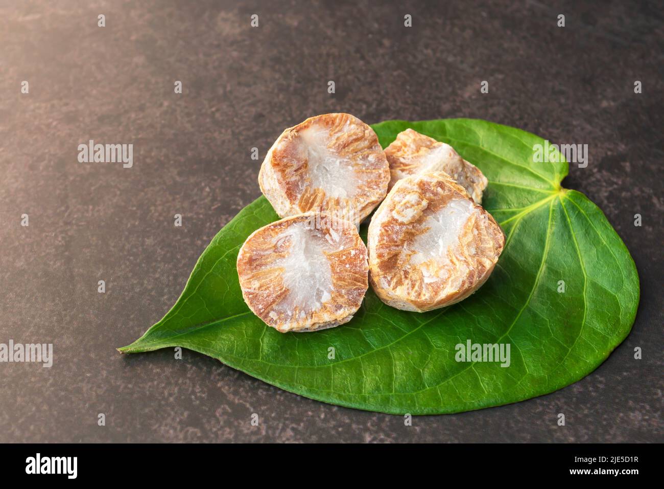Fresh betel nut or areca nut with betel leaf isolated on dark ...