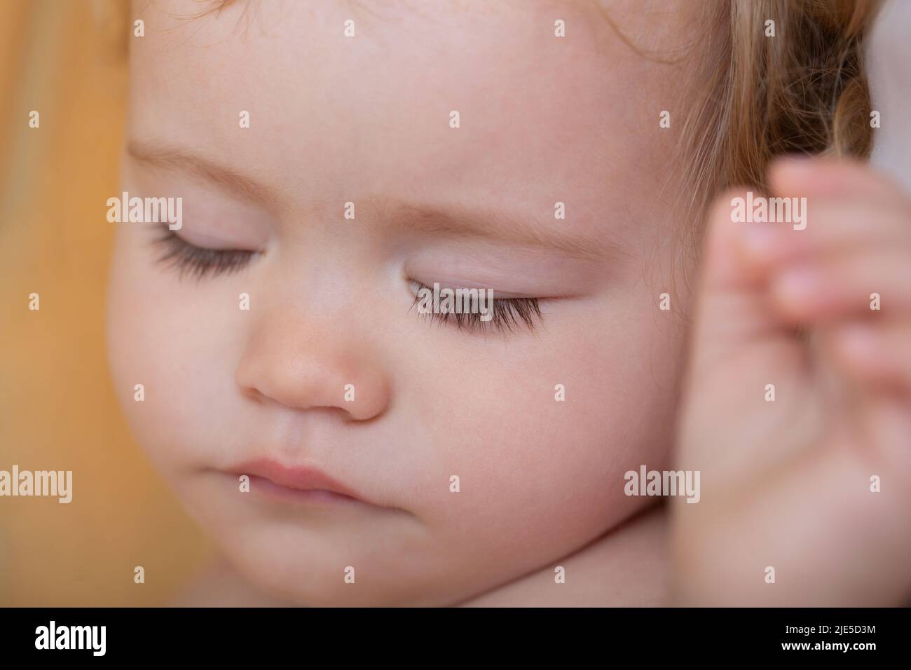 Macro face of cute baby child sleeping in the bed. Closeup sleepy kids ...