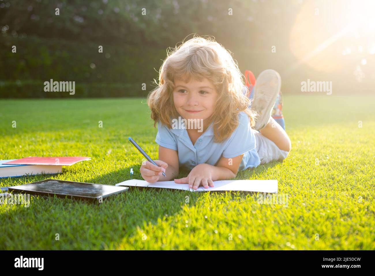 Cute childr boy writing notes in copybook outdoors. Summer camp. Kids ...