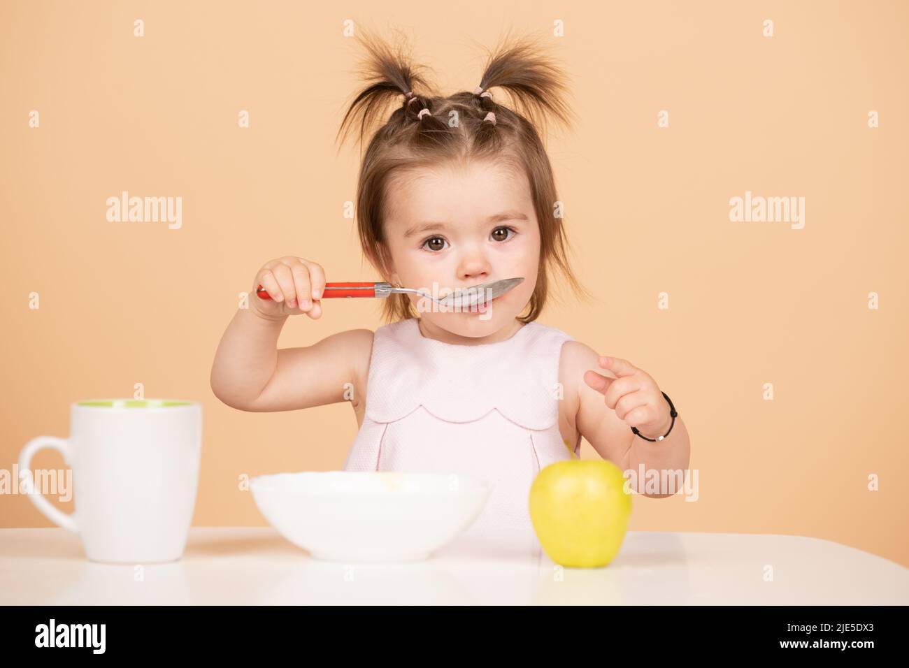 Kid eat healthy nutrition, baby food. Babies eating with spoon. Kid ...
