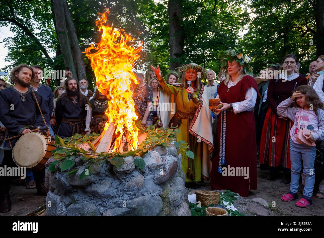 Women in Lithuanian national costumes perform rituals with freshly ...