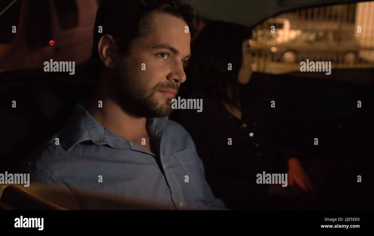 People inside car backseat at night. Man and woman riding taxi cab ...