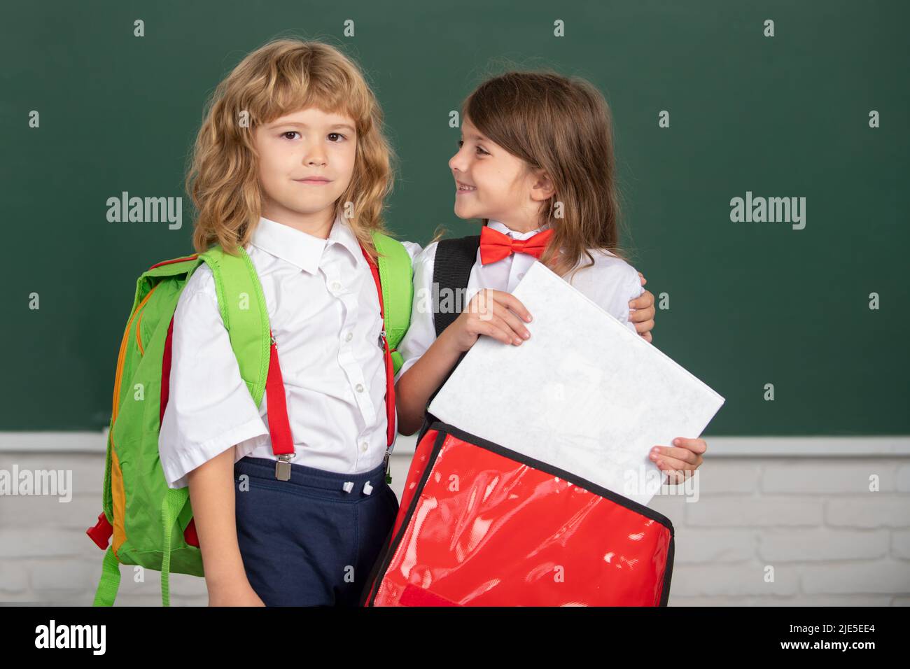 Happy girl and boy school friends. Face portrait of two schoolkids ...