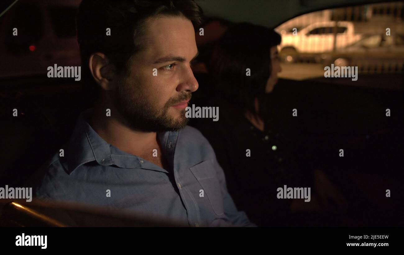 People inside car backseat at night. Man and woman riding taxi cab ...