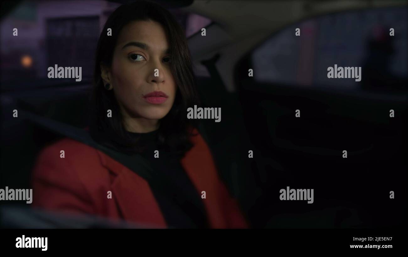 One anxious person stuck in traffic in car backseat. Young woman ...