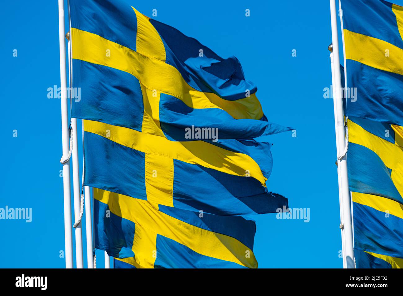 Several swedish flags flying on flagpoles Stock Photo - Alamy