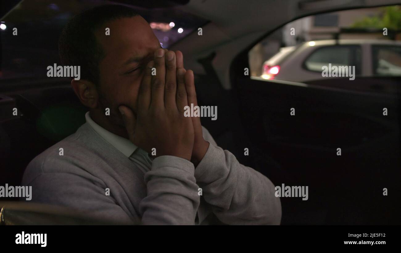 Anxious person in car backseat commuting at night after work inside ...