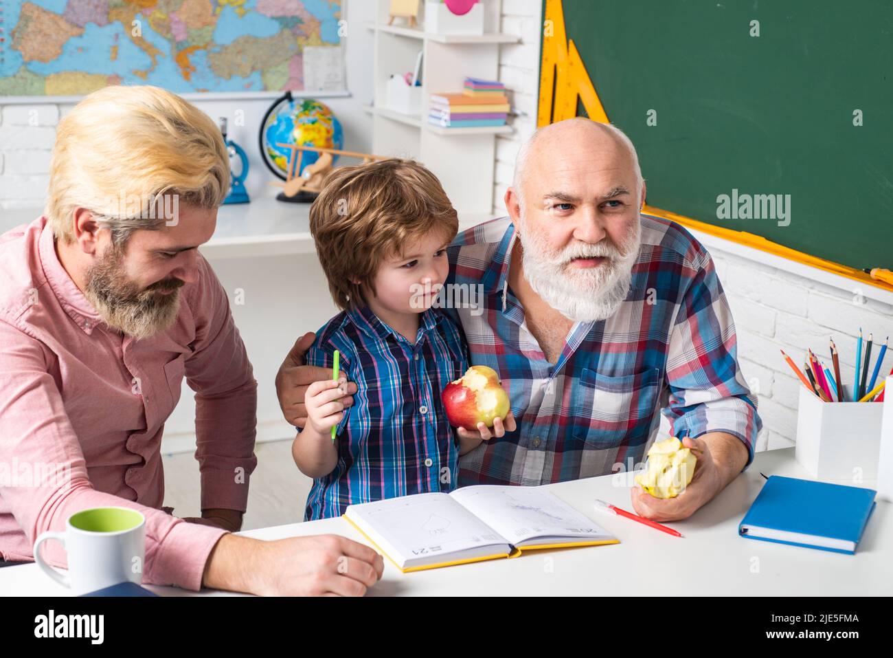 Father and son playing in school class learning to write and read ...