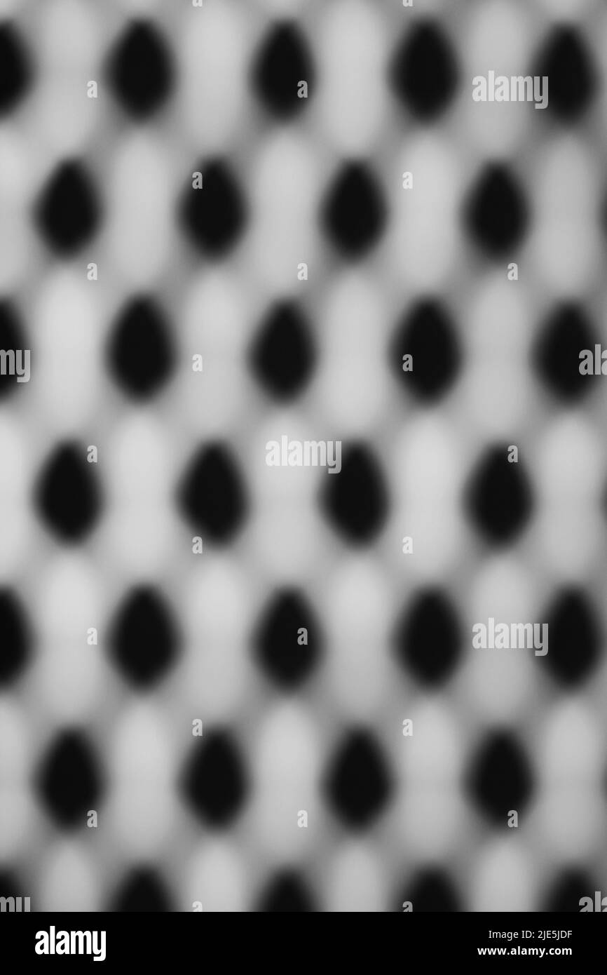 Repeating black and white pattern of egg shaped circles connected with ...