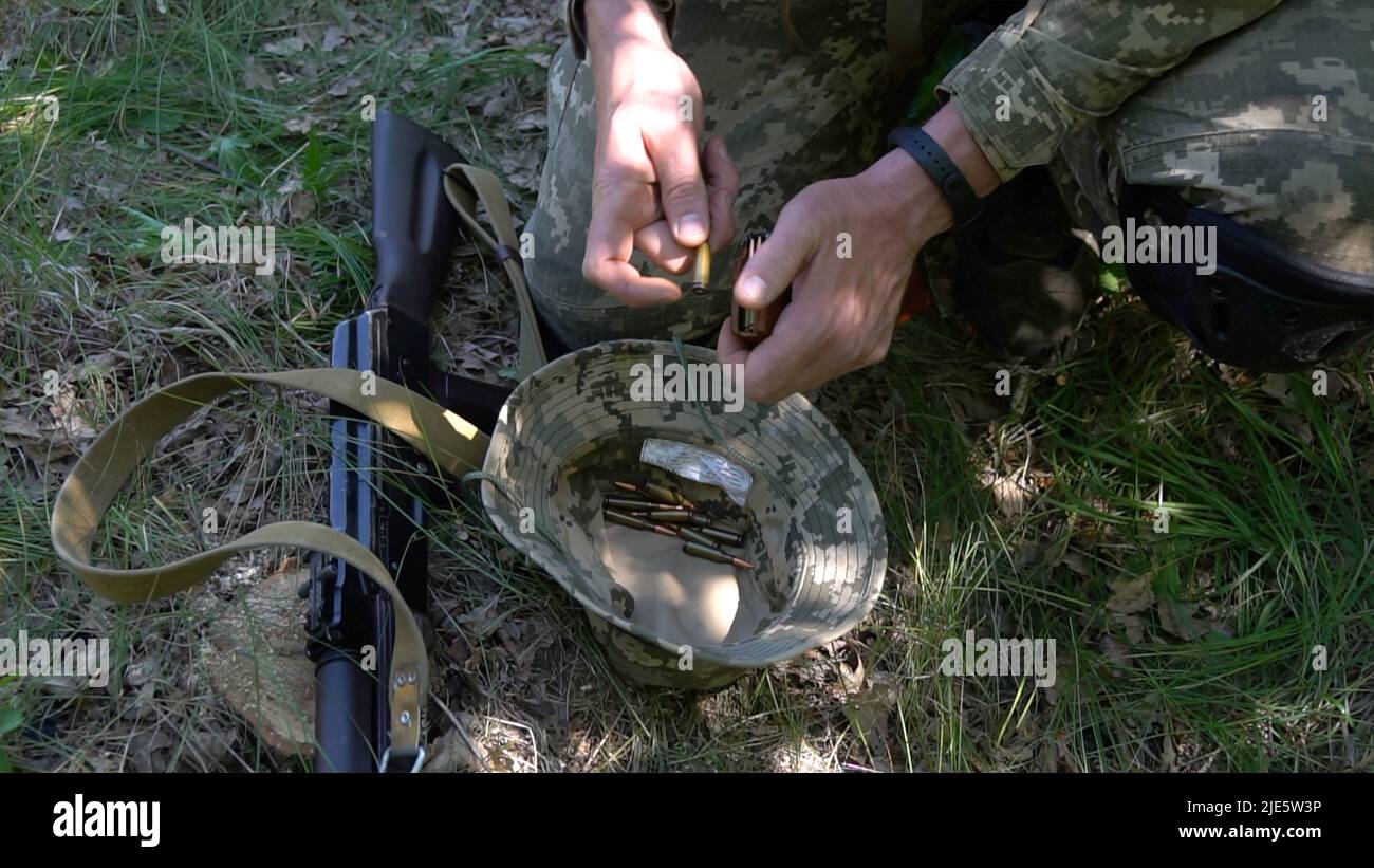 Ukrainian soldier loads machine gun magazine with cartridges Stock ...