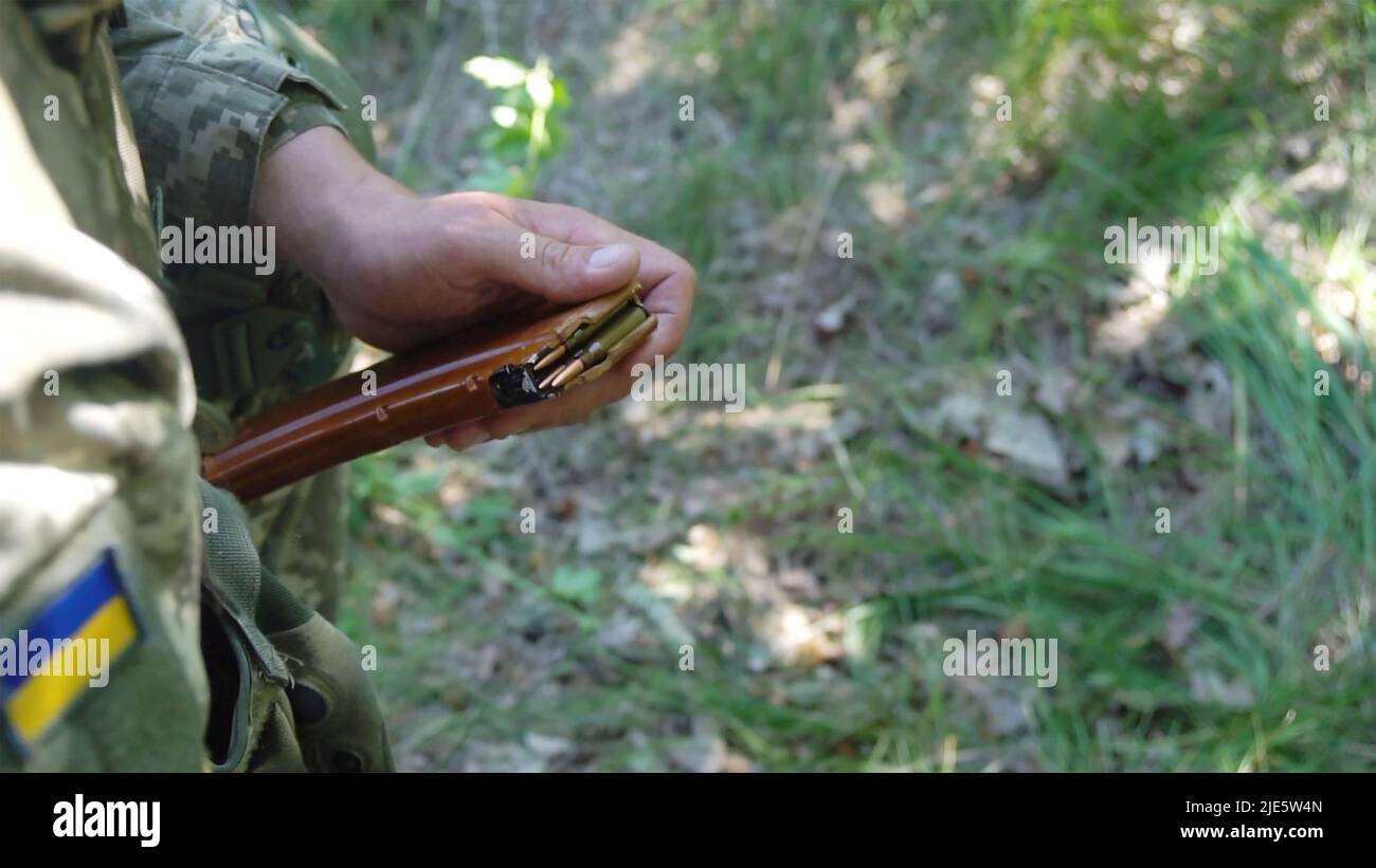 Ukrainian soldier loads machine gun magazine with cartridges Stock ...