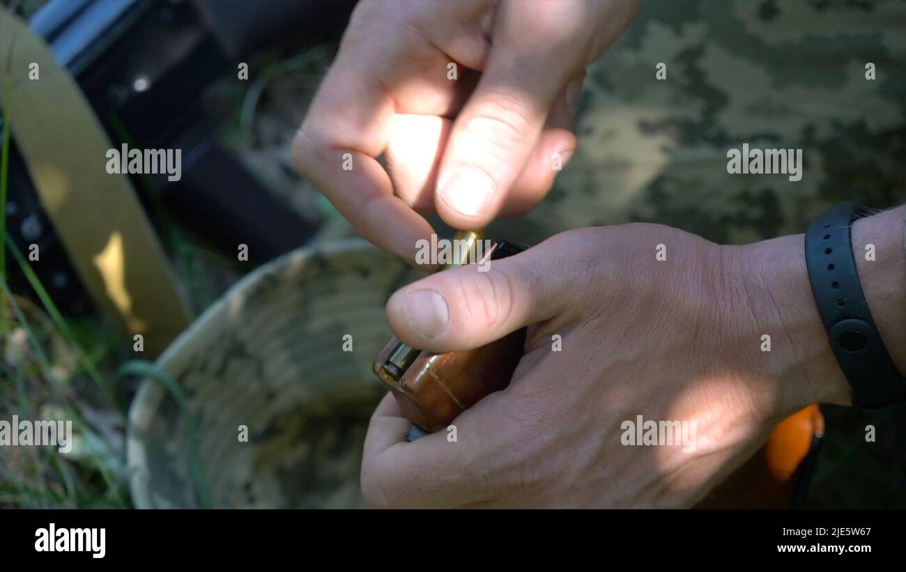 Ukrainian soldier loads machine gun magazine with cartridges Stock ...