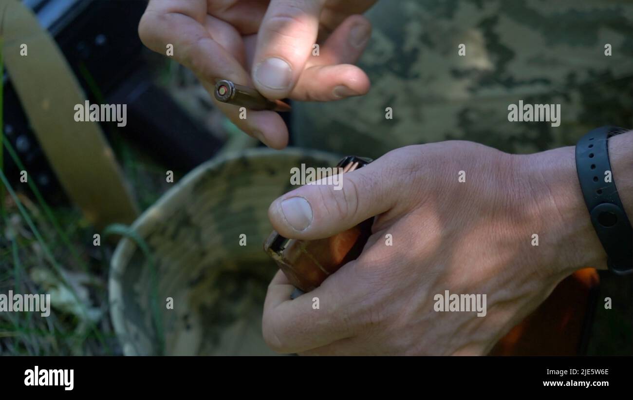 Ukrainian soldier loads machine gun magazine with cartridges Stock ...