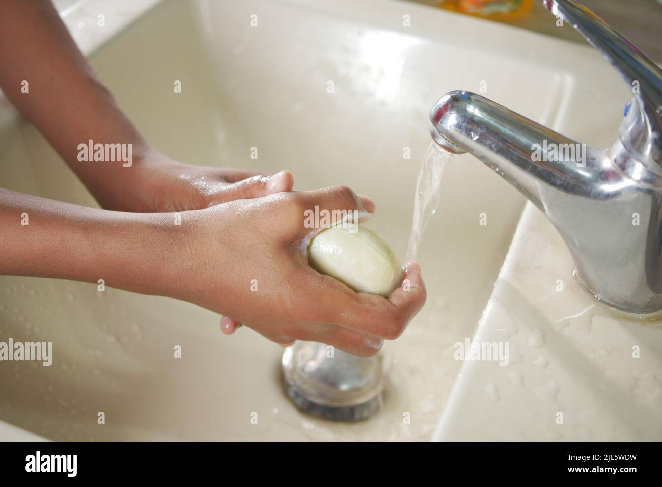 young man washing hands with soap warm water Stock Photo - Alamy