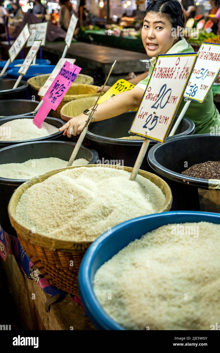 Benny, cooking instructor at Thai Farm Cooking School, at rice stand ...