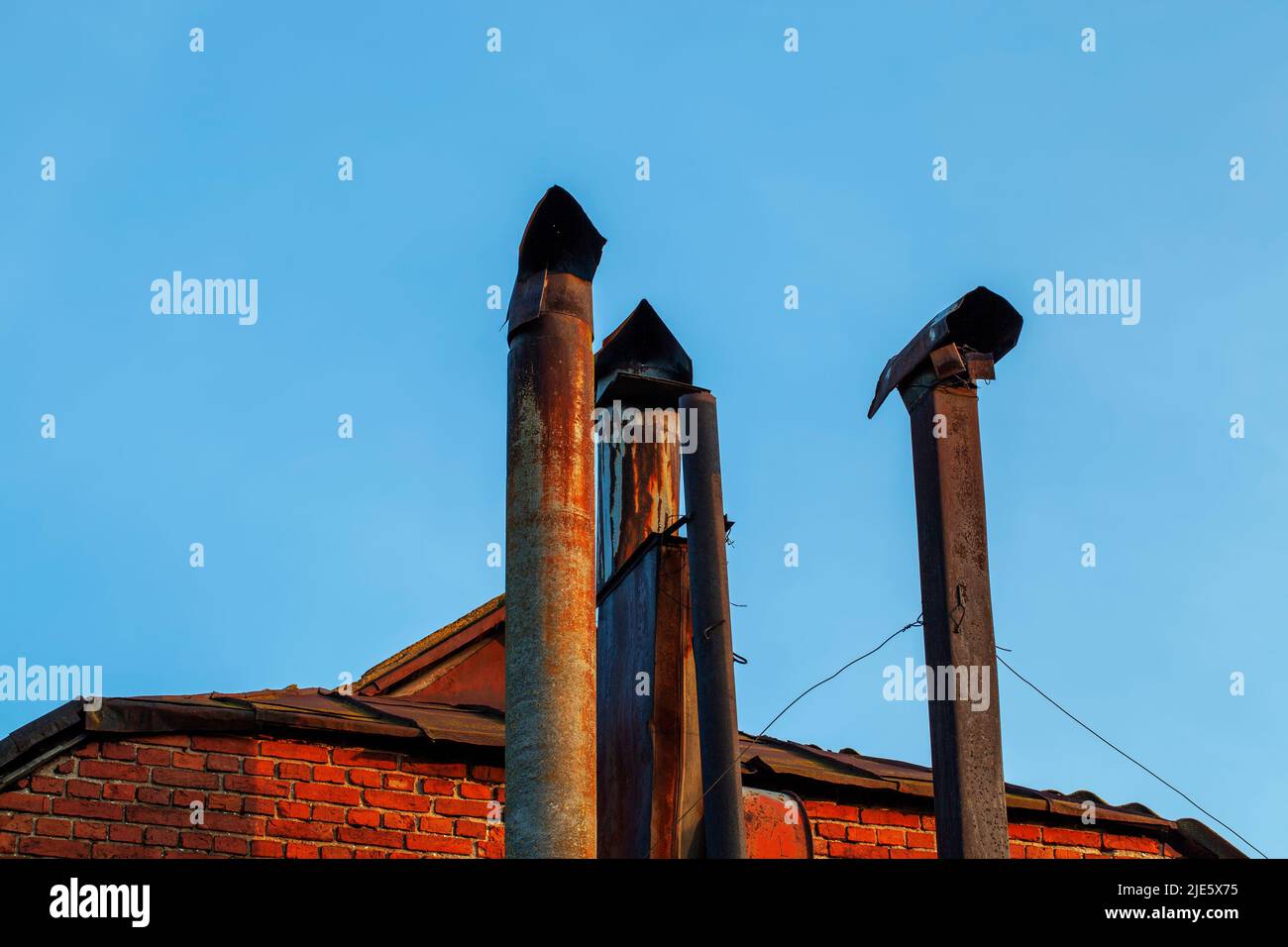 old chimney on the roof of the building, old heating system with a ...