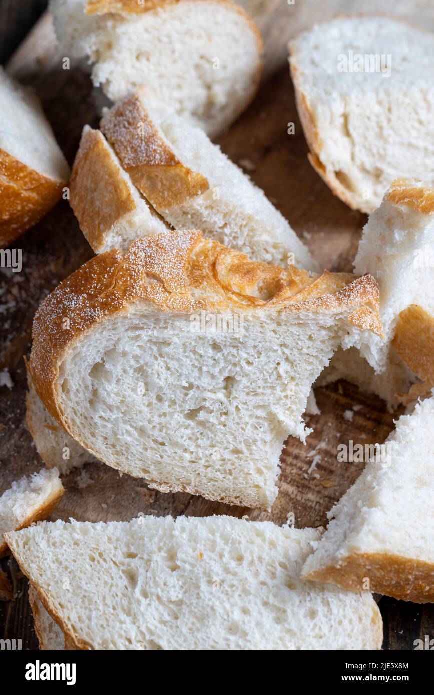 sliced loaf of bread on a cutting wooden board, rye loaf of bread cut ...