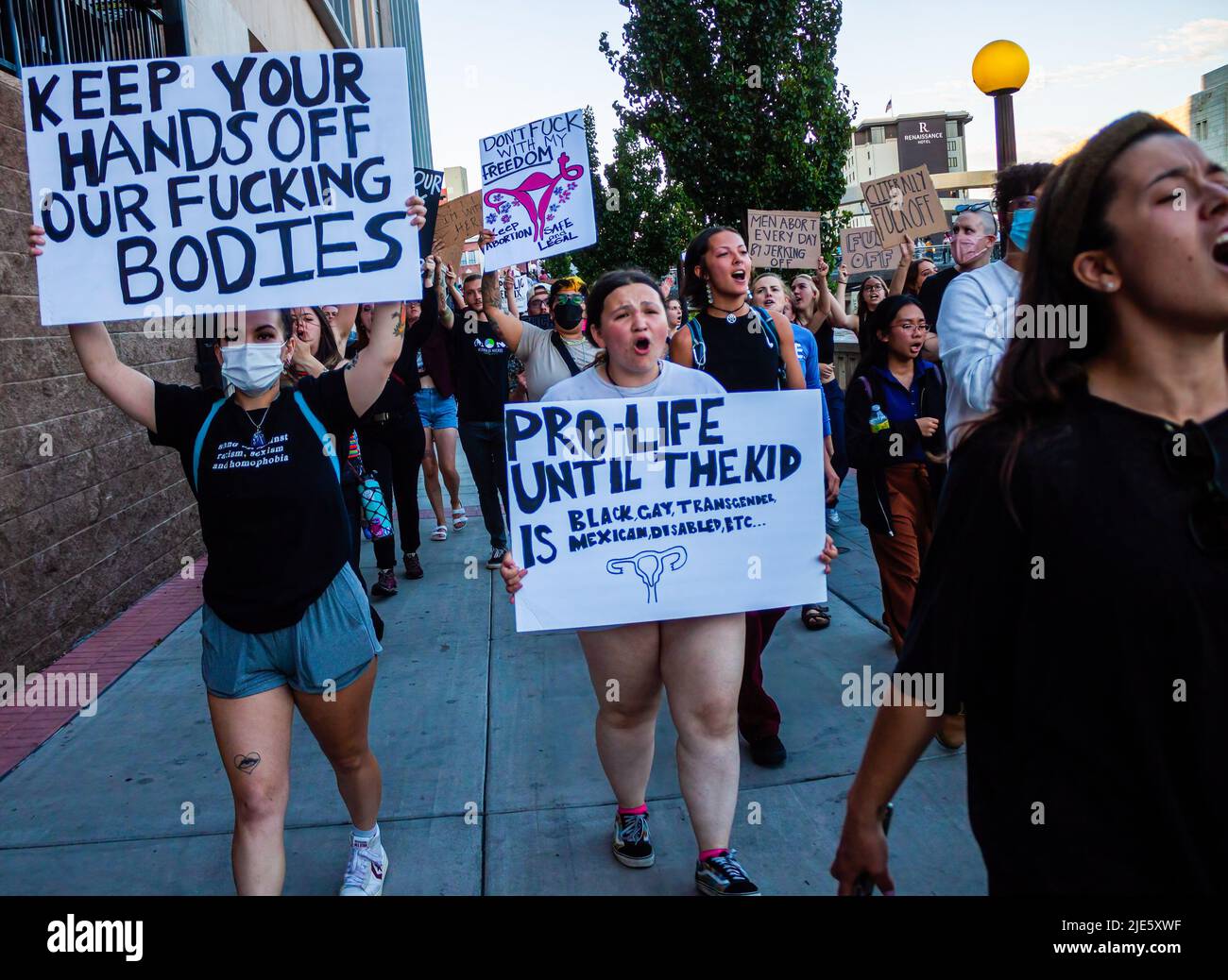 (Editors note image depicts profanity) Protesters march with placards ...