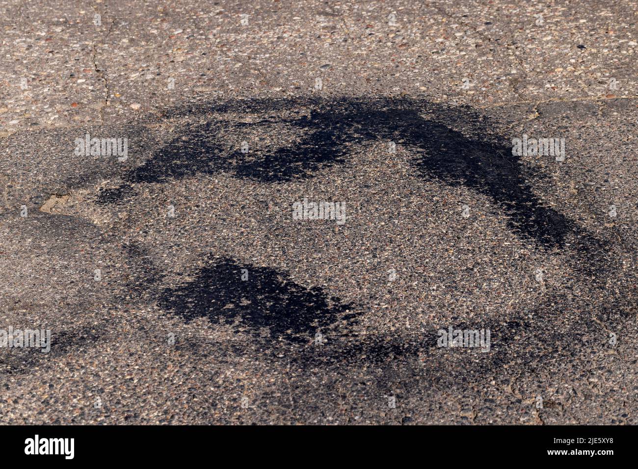 a highway with oil stains on the surface, a polluted highway from ...