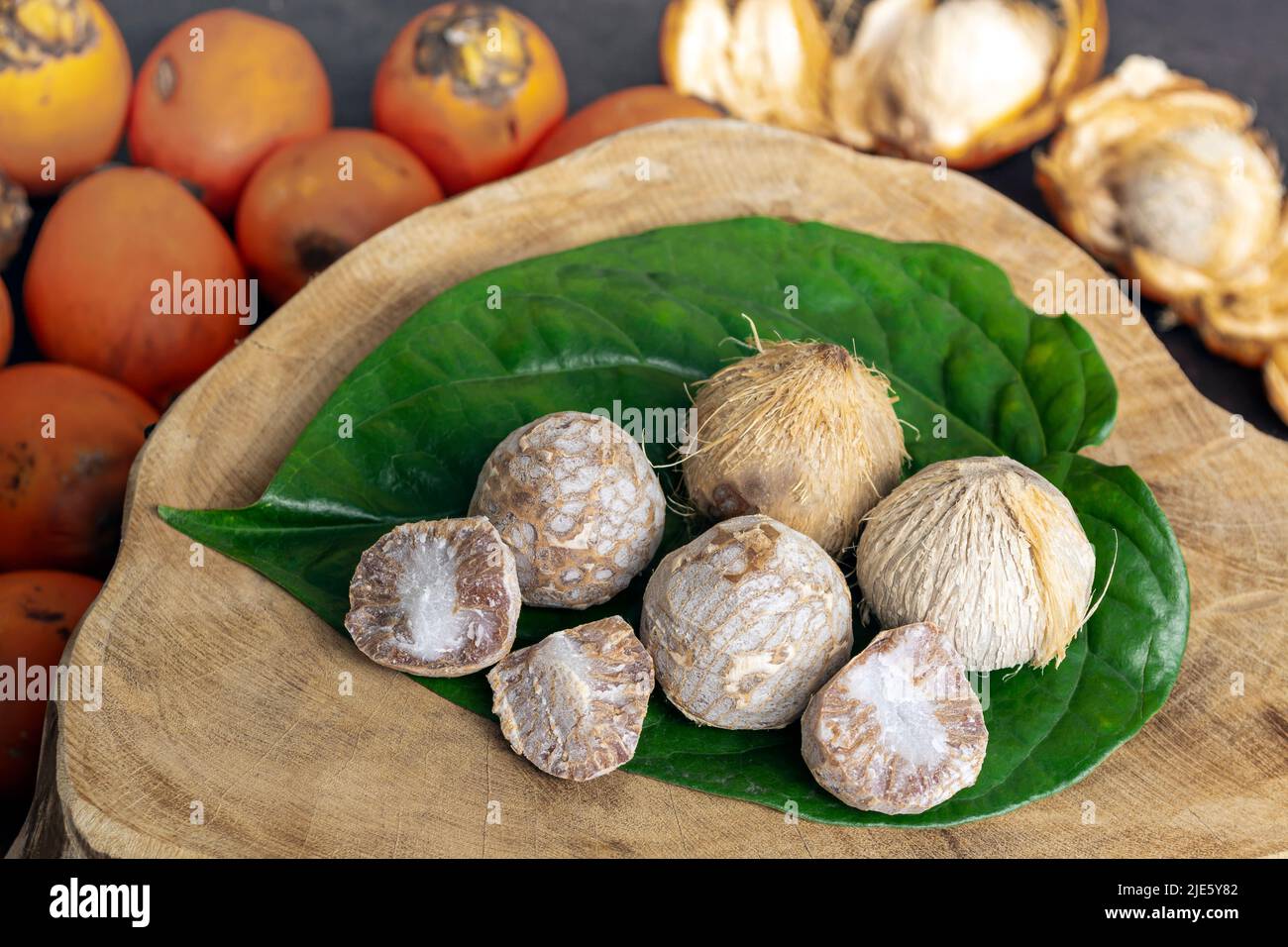 Ripe Betel nut or areca nut with betel leaf isolated on wooden ...