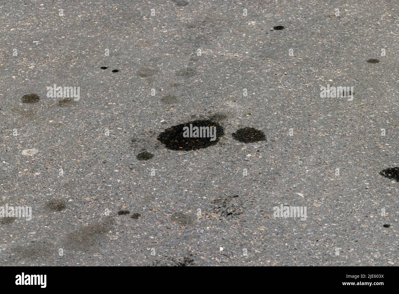 a highway with oil stains on the surface, a polluted highway from ...