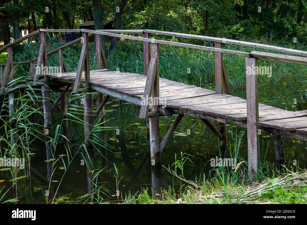 old wooden bridge over a small river, old rural wooden bridge built ...