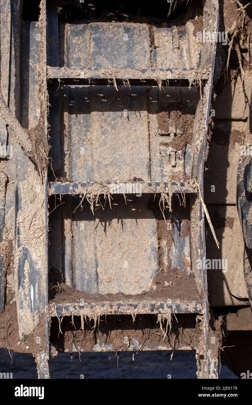 the metal ladder on the tractor is covered in dirt after agricultural ...