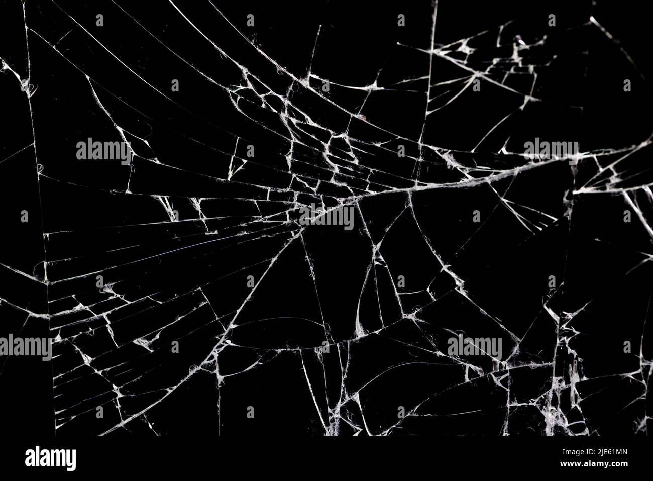 old dirty glass with a lot of cracks, old broken glass on a black ...