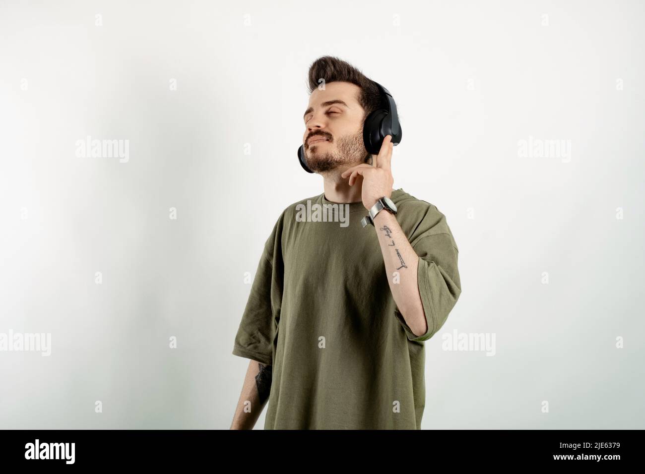 Caucasian young man wearing t-shirt posing isolated over white ...