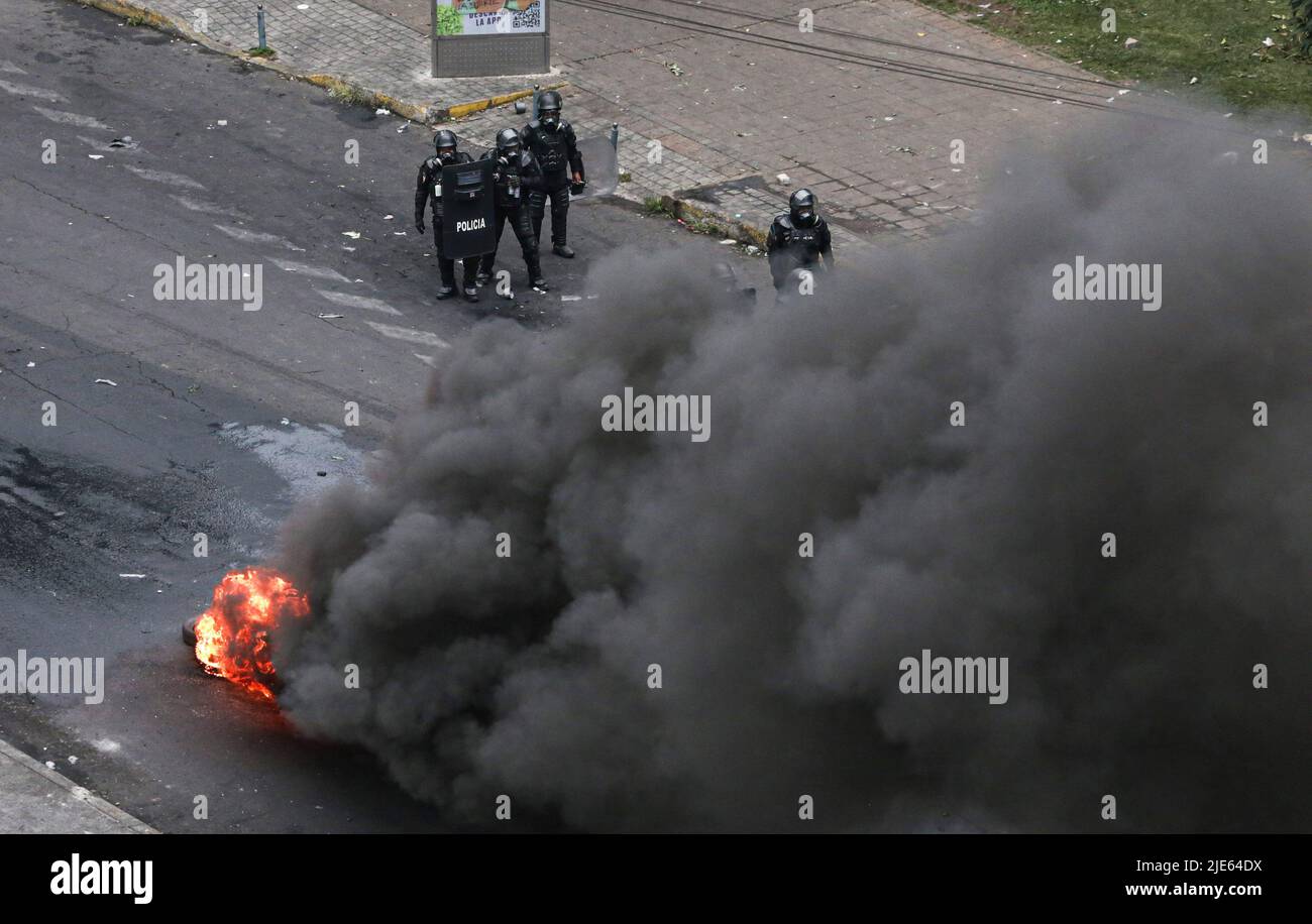 Riot police advance through the street where they cleared the ...