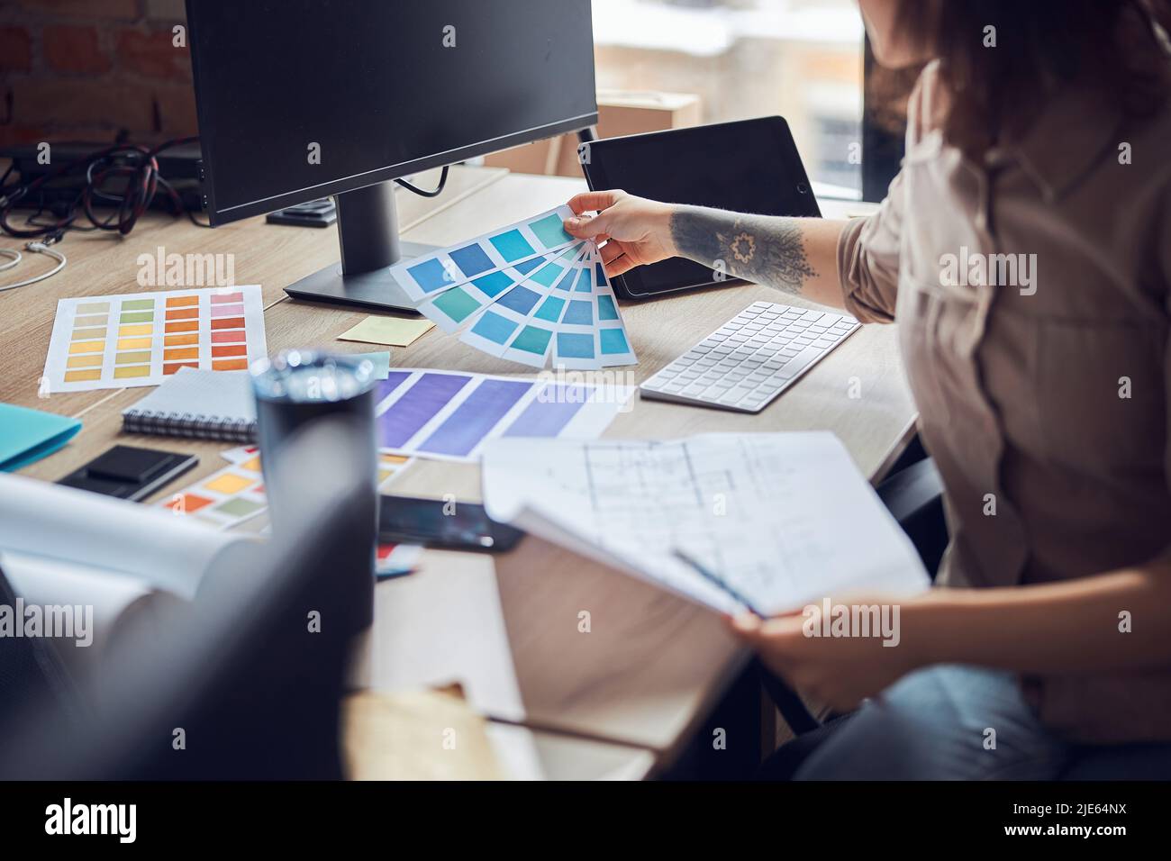 Woman choosing color samples palette while working on new interior ...