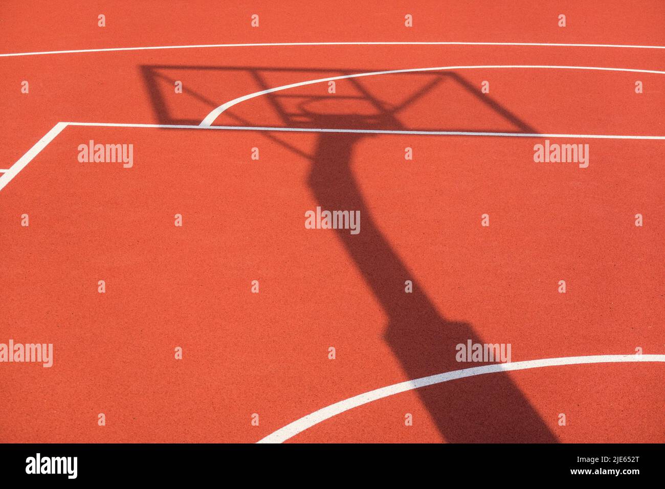 Shadow of the rack with shield and basketball ring on orange basketball ...