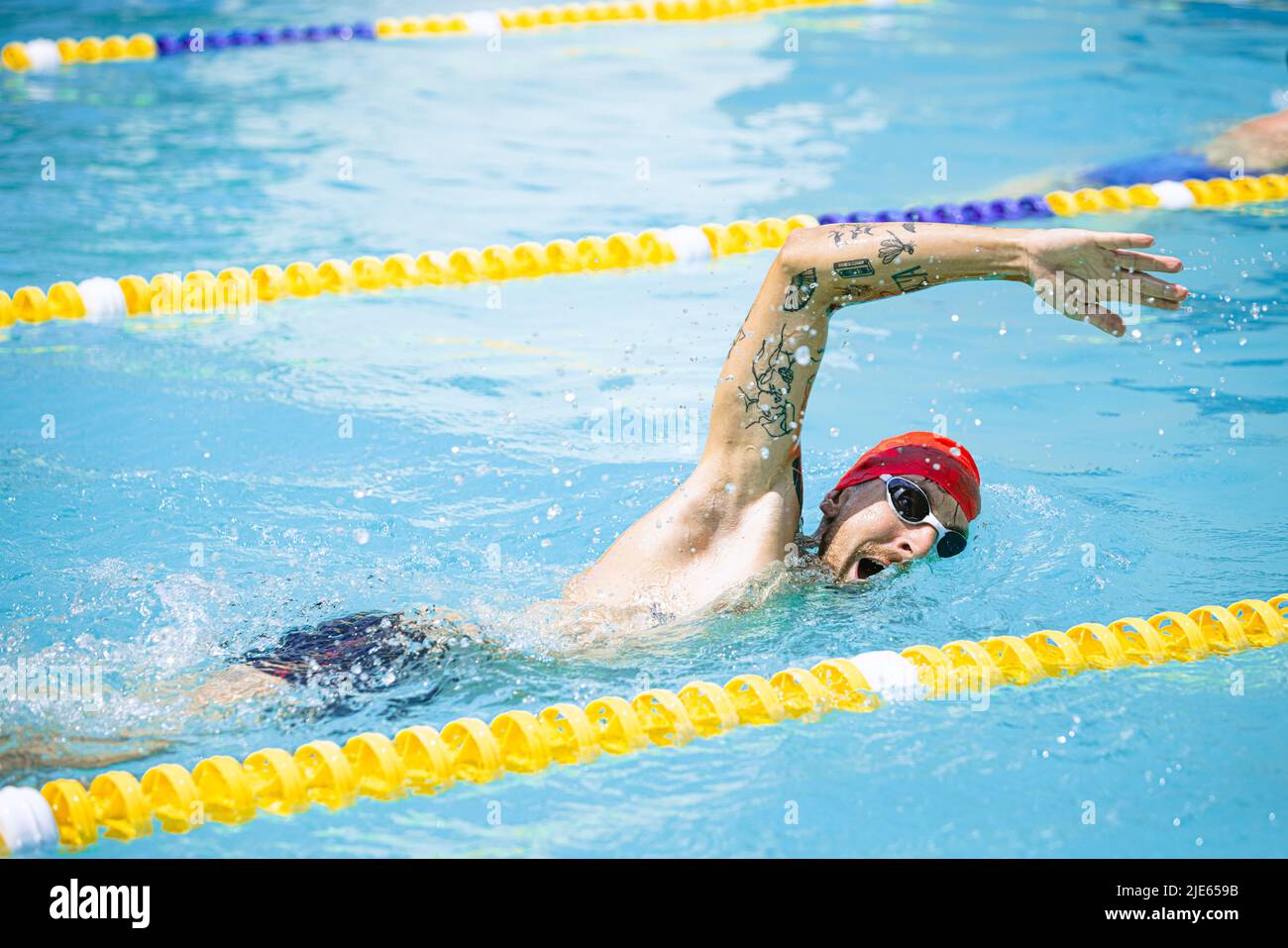 One muscular man, professional swimmer in goggles training at public ...