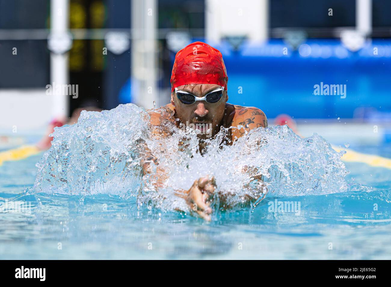 One muscular man, professional swimmer in goggles training at public ...