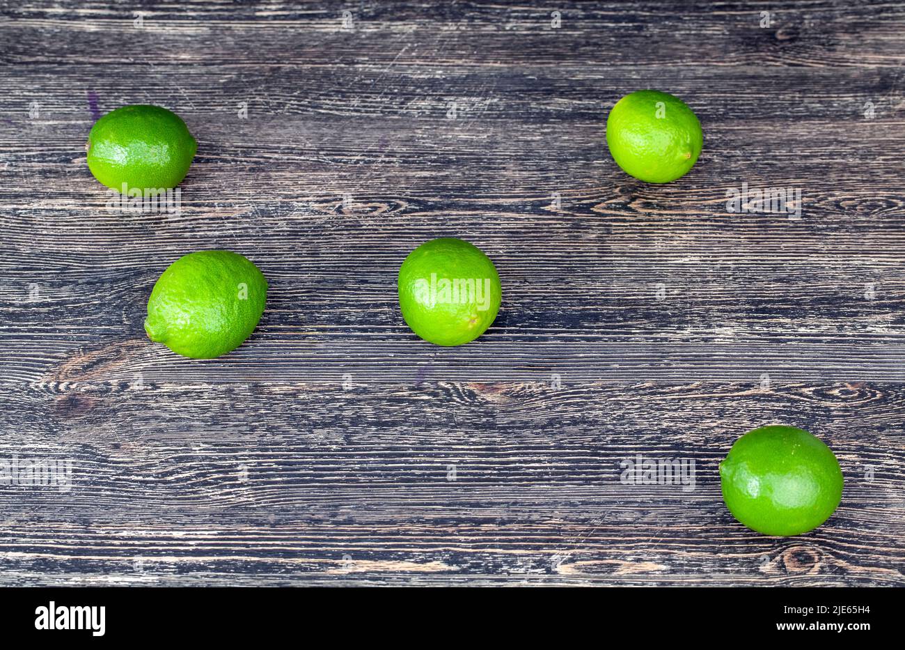 green ripe limes on the kitchen table, green sour citrus limes during ...