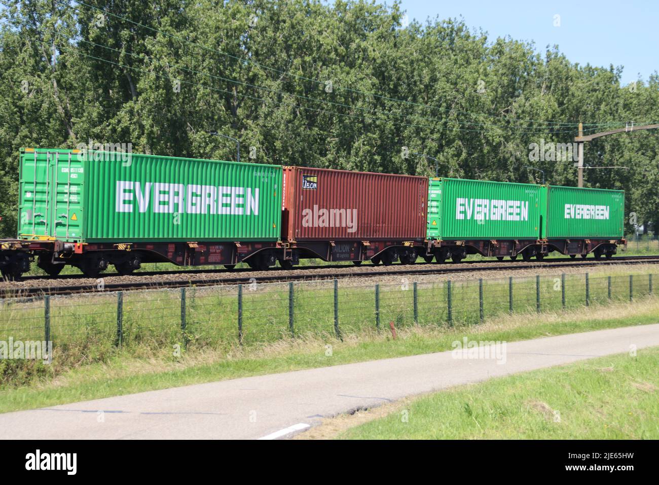 Traxx locomotive with container freight train on track close to ...